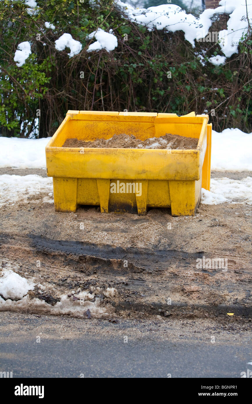 Grit bin with mushy grit surrounding it with melting snow and ice Stock ...