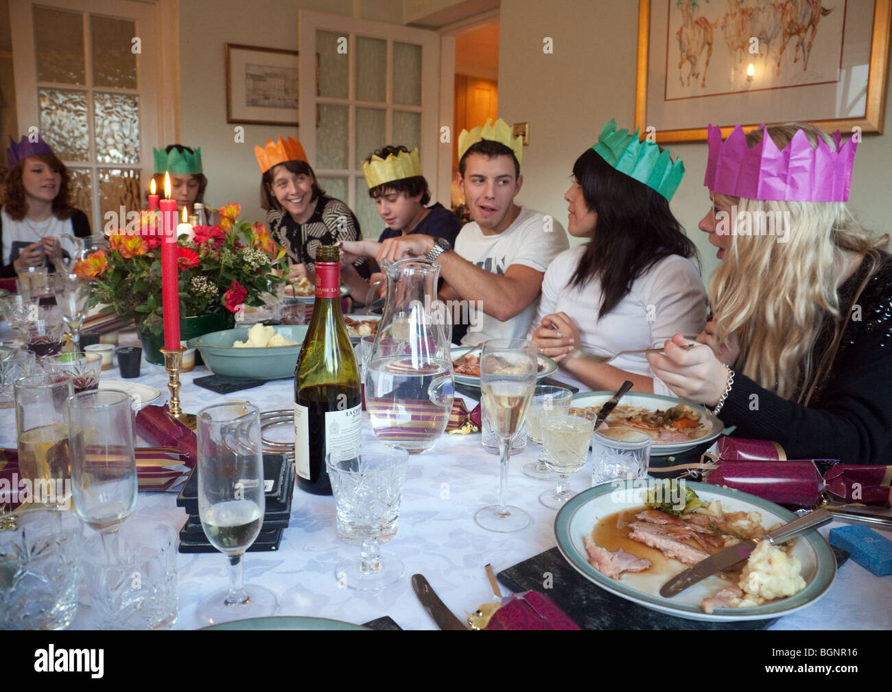 Family Christmas UK; family and friends at a Christmas dinner party on ...