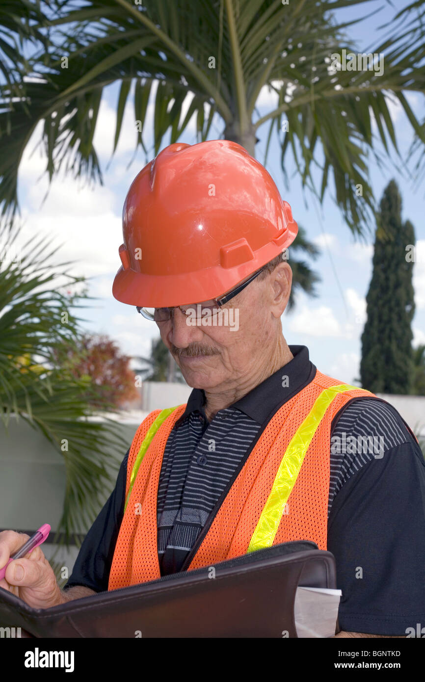 Construction man taking notes Stock Photo - Alamy