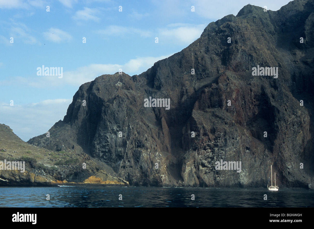 Cliff with a sailing boat at Punta Vicente Roca, Isabela Island ...