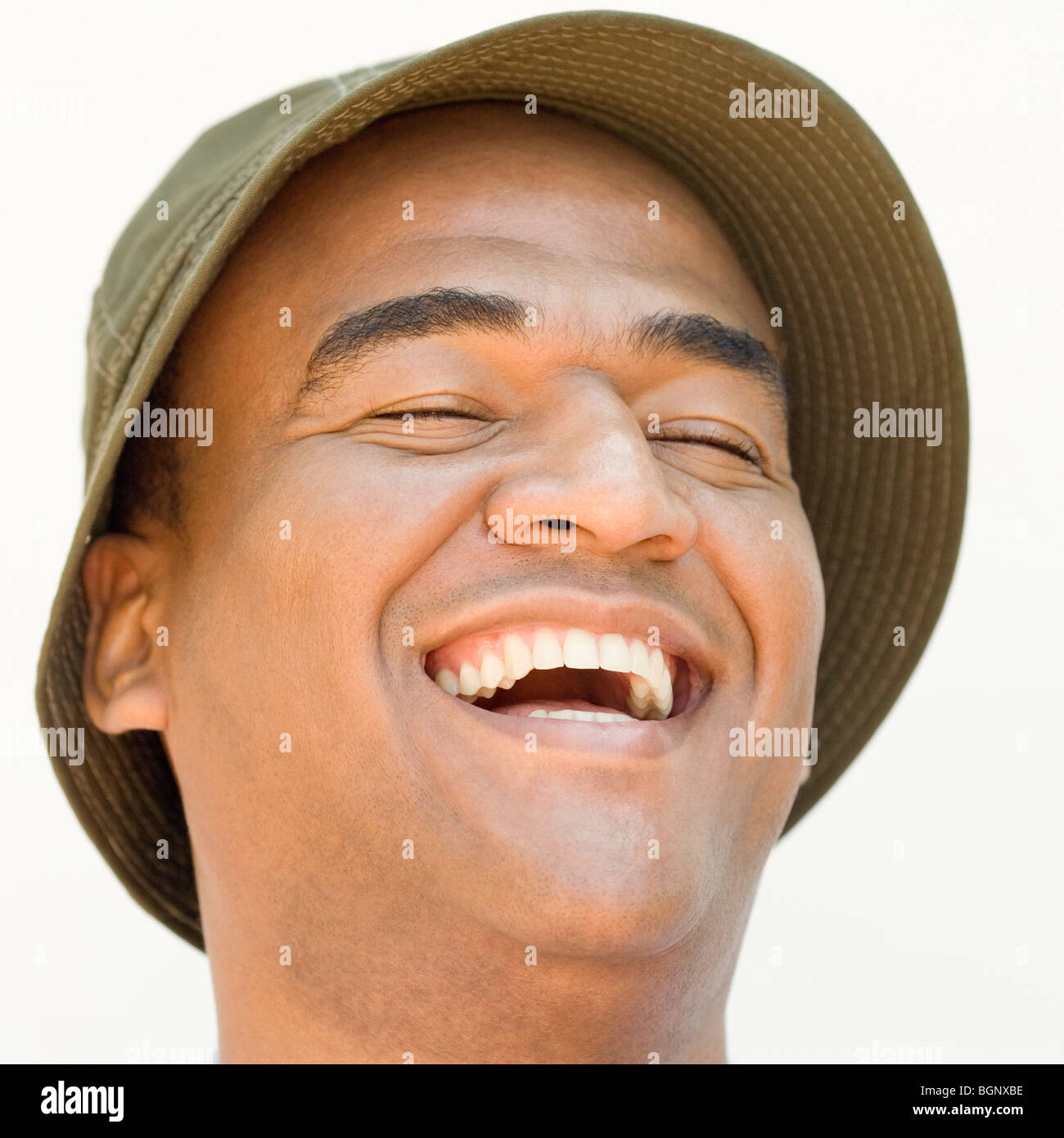 Close-up of a mid adult man laughing with his eyes closed Stock Photo ...
