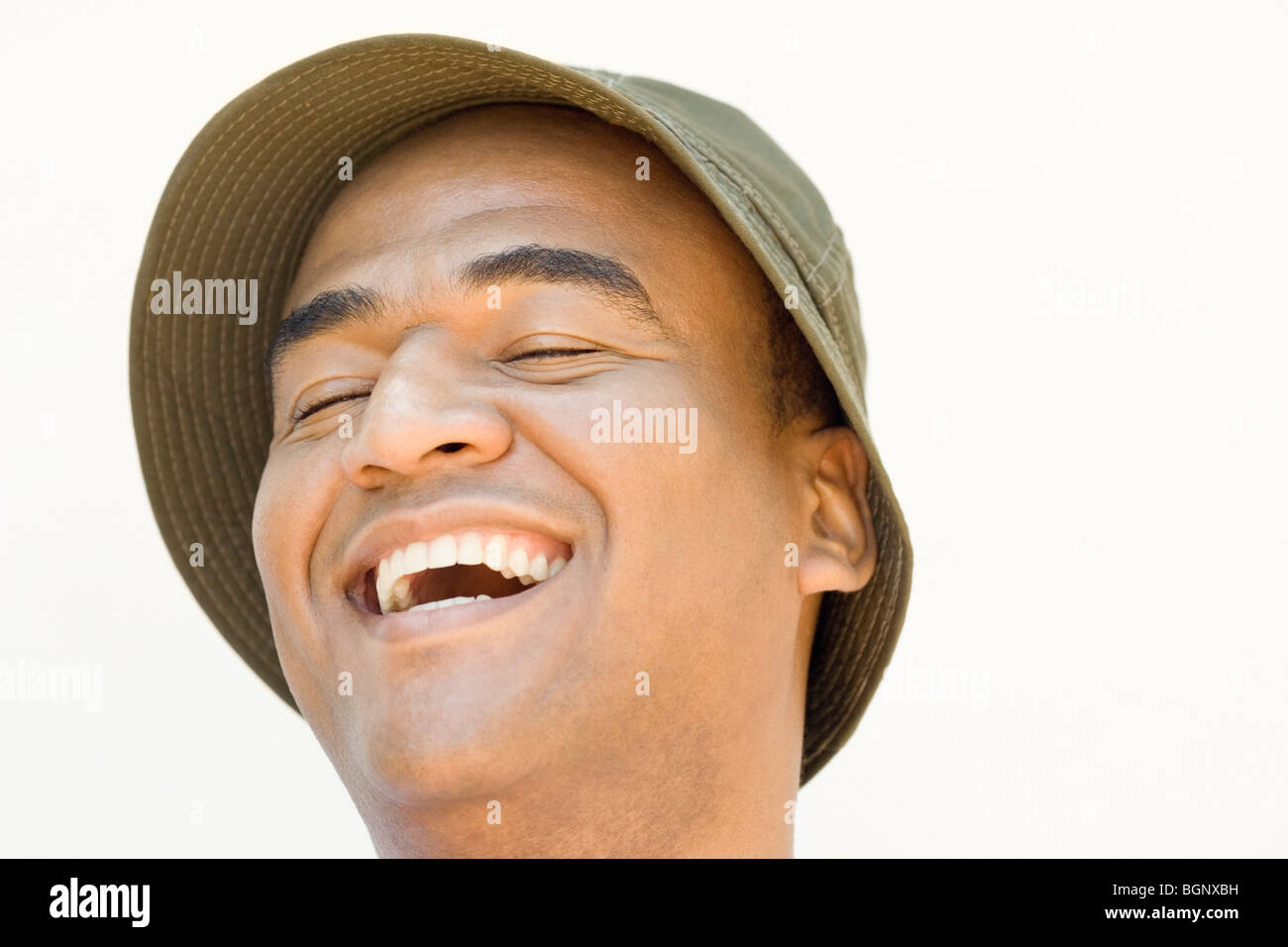 Close-up of a mid adult man laughing with his eyes closed Stock Photo ...