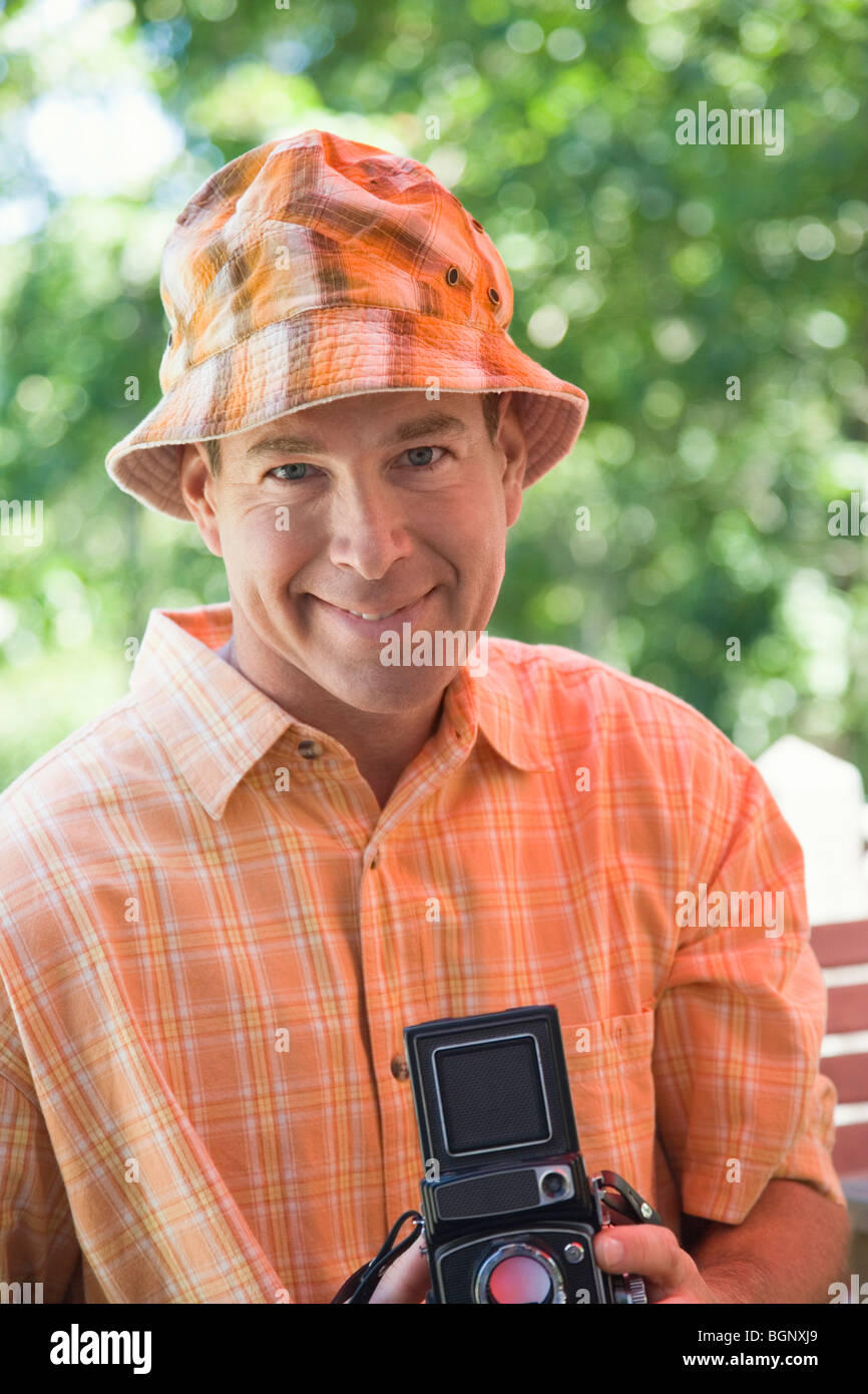 Portrait of a mature man holding a TLR camera Stock Photo - Alamy
