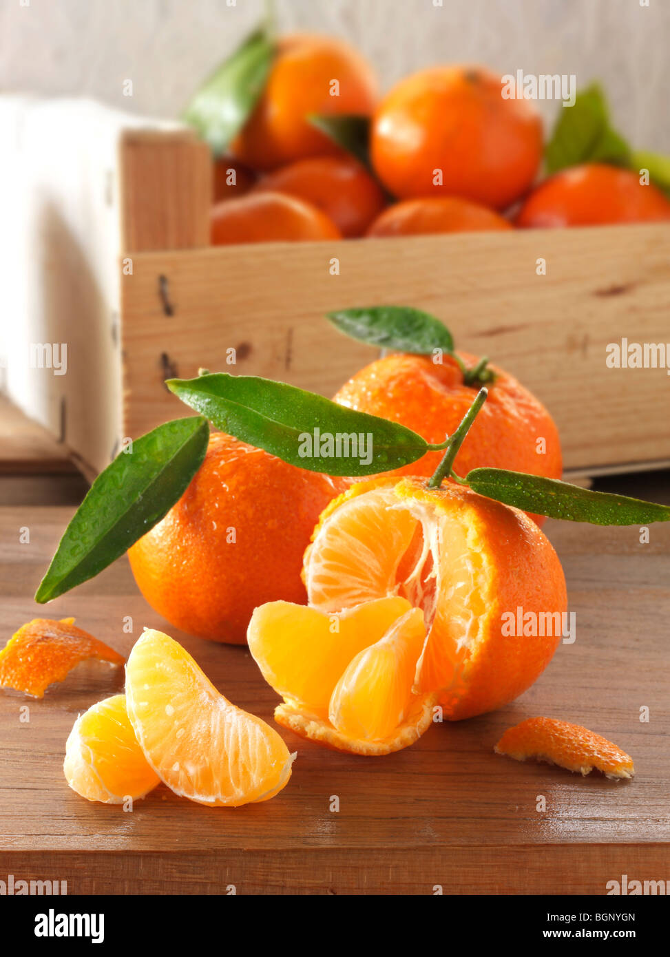 Fresh whole clamentines and segments with a box of clamentines in a ...