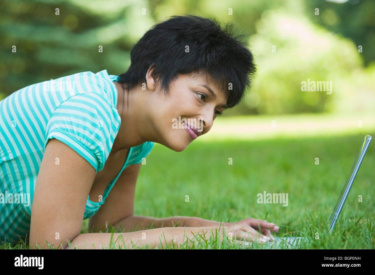 Side profile of a businesswoman using a laptop Stock Photo - Alamy