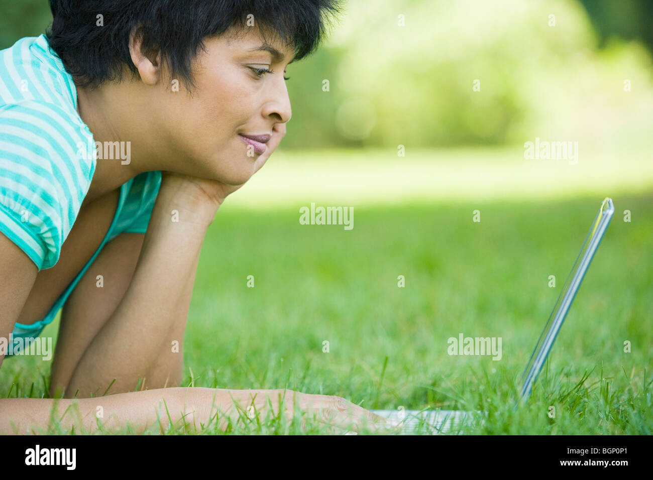 Side profile of a businesswoman using a laptop Stock Photo - Alamy
