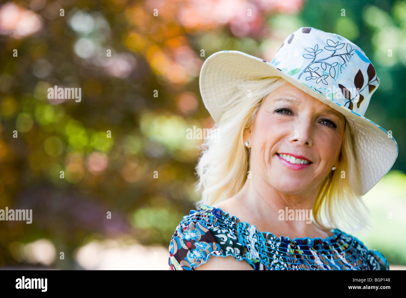 Portrait of a mature woman wearing a hat Stock Photo - Alamy