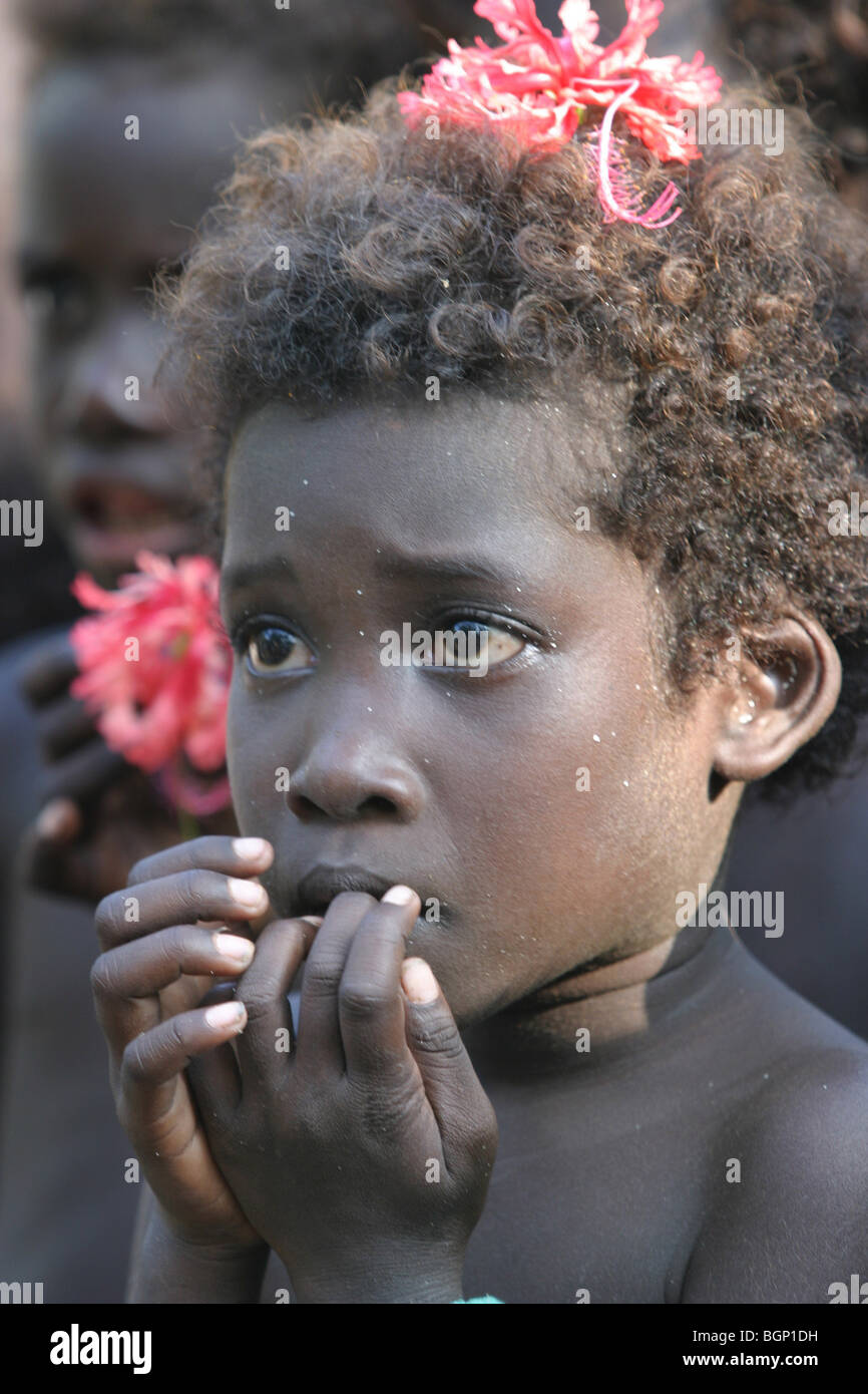 island girl stands apprehensively listening to elders talk of the ...
