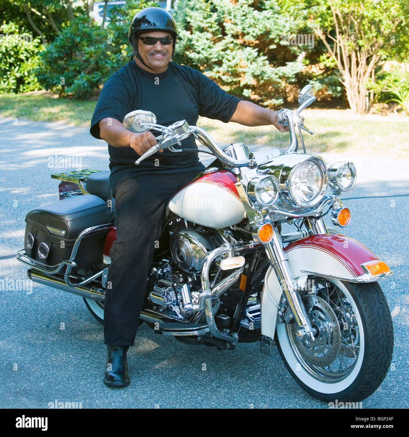 Senior man riding a motorcycle and smiling Stock Photo - Alamy