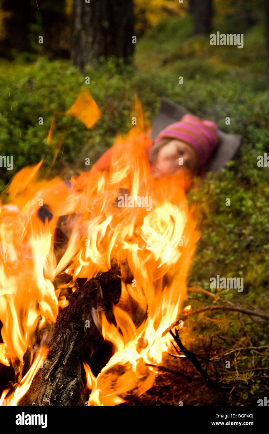 A girl by a camp fire in a forest, Sweden Stock Photo - Alamy