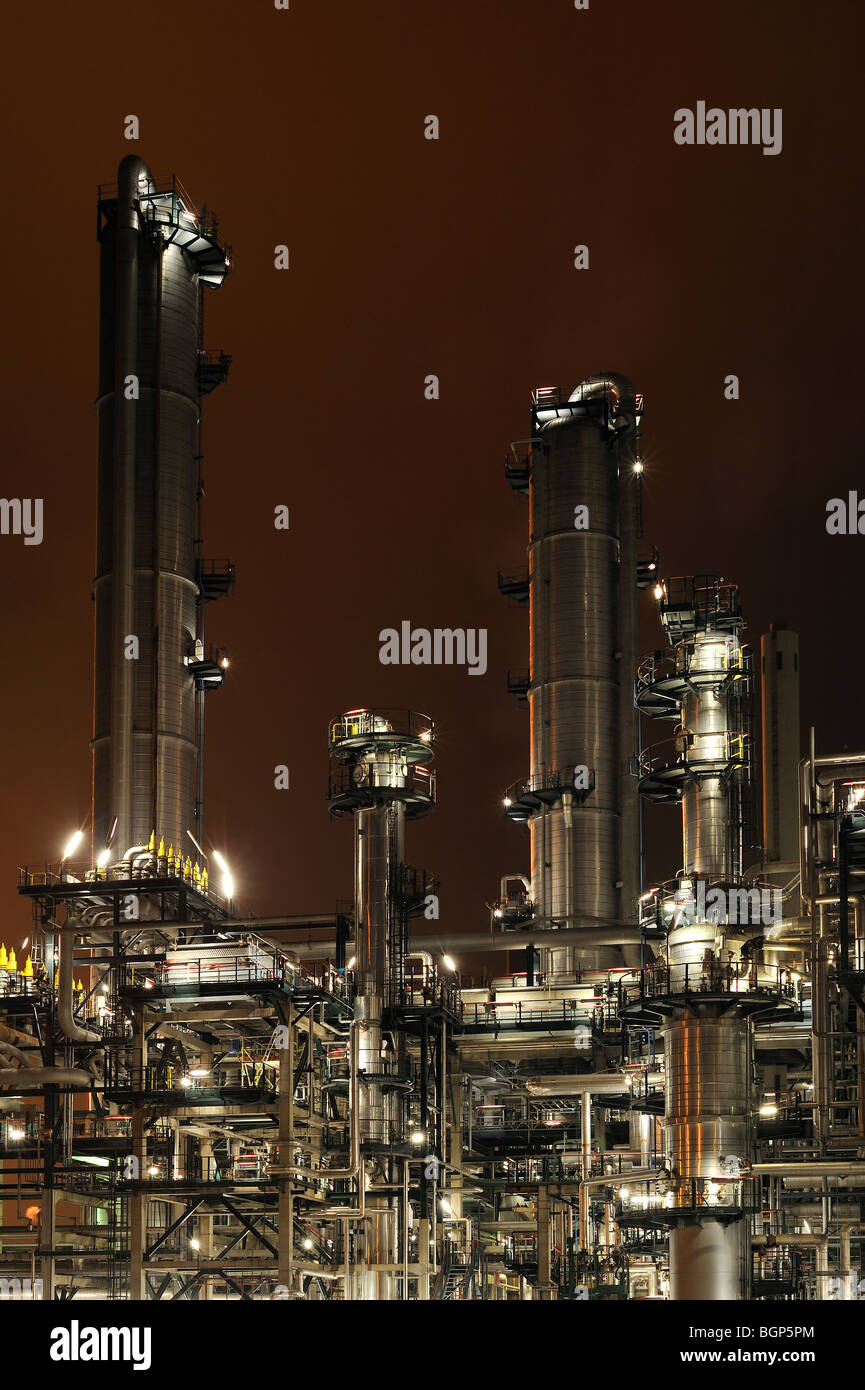Refinery chimneys of petrochemical industry illuminated at night Stock ...