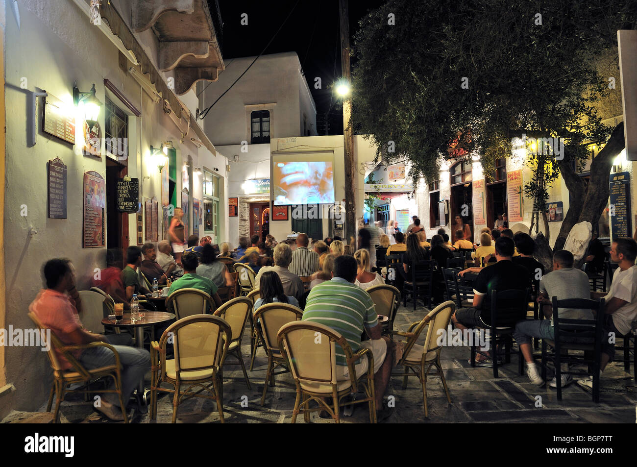 People watching football at main square, Chora (main town), Ios island ...