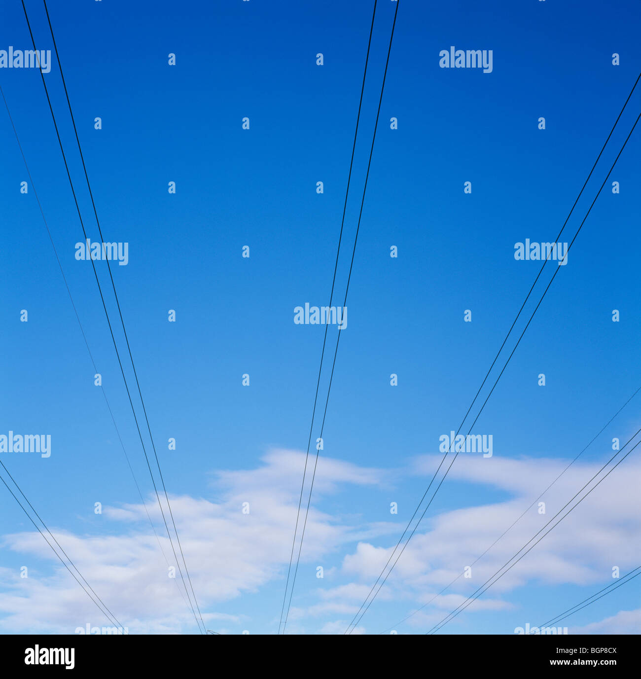 Electric lines in the blue sky Stock Photo - Alamy
