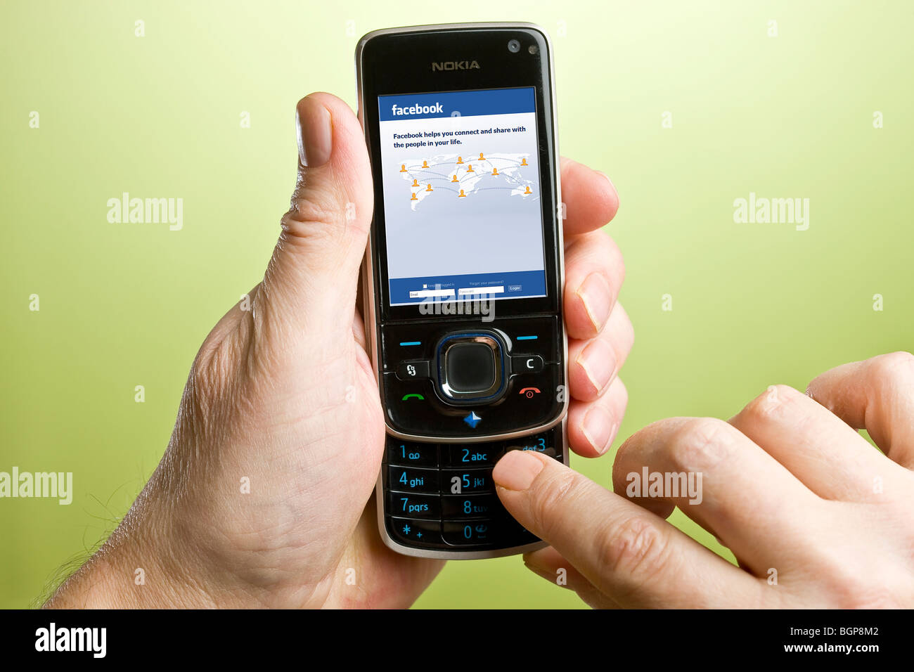 Using Facebook on a mobile phone Stock Photo - Alamy