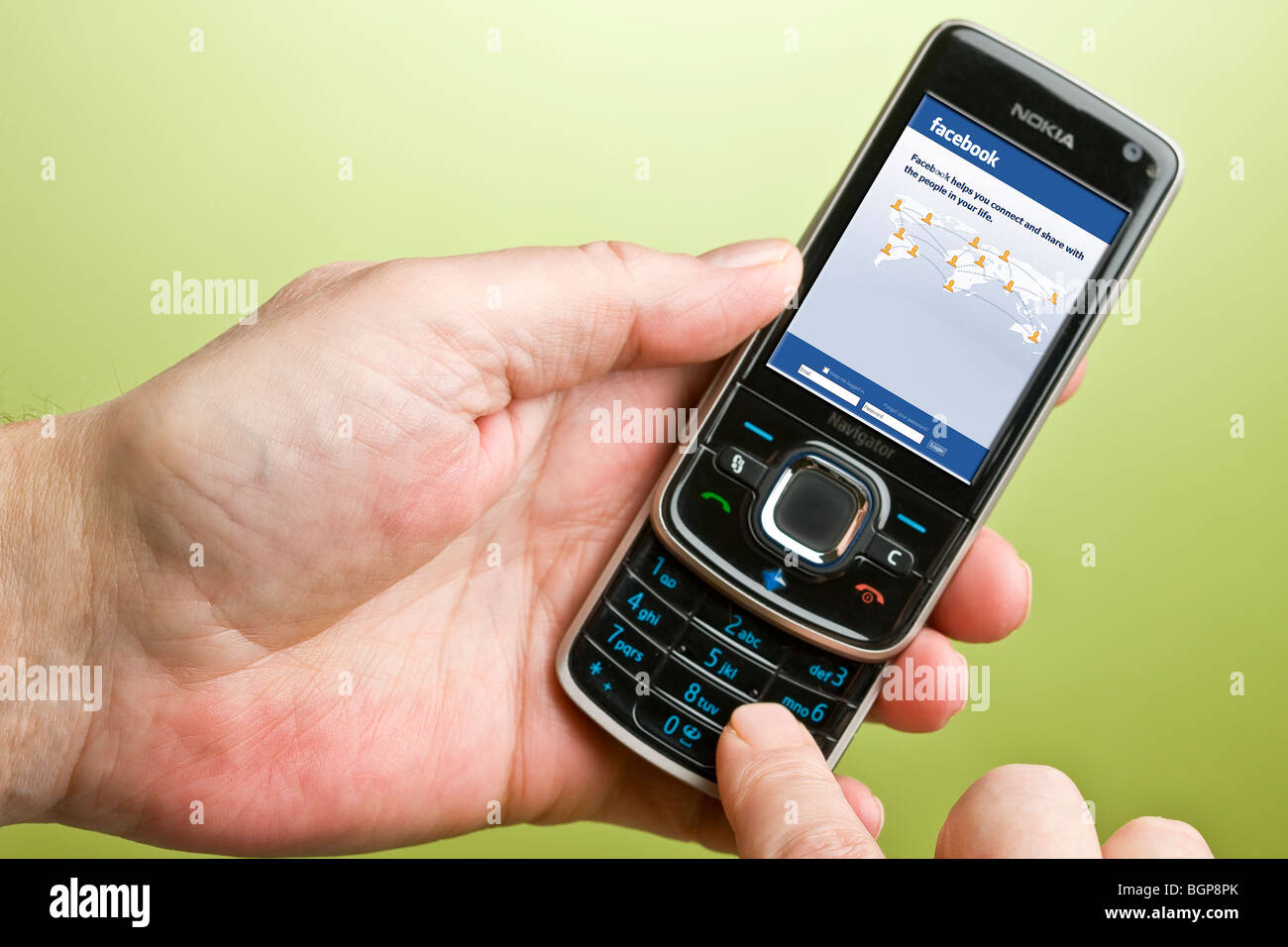 Using Facebook on a mobile phone Stock Photo - Alamy