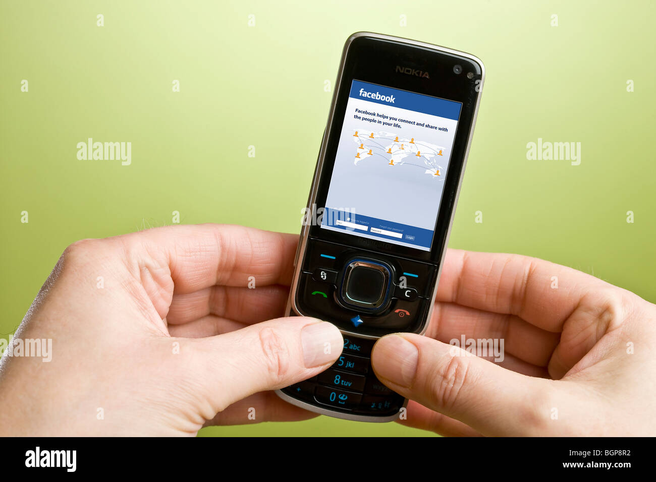 Using Facebook on a mobile phone Stock Photo - Alamy