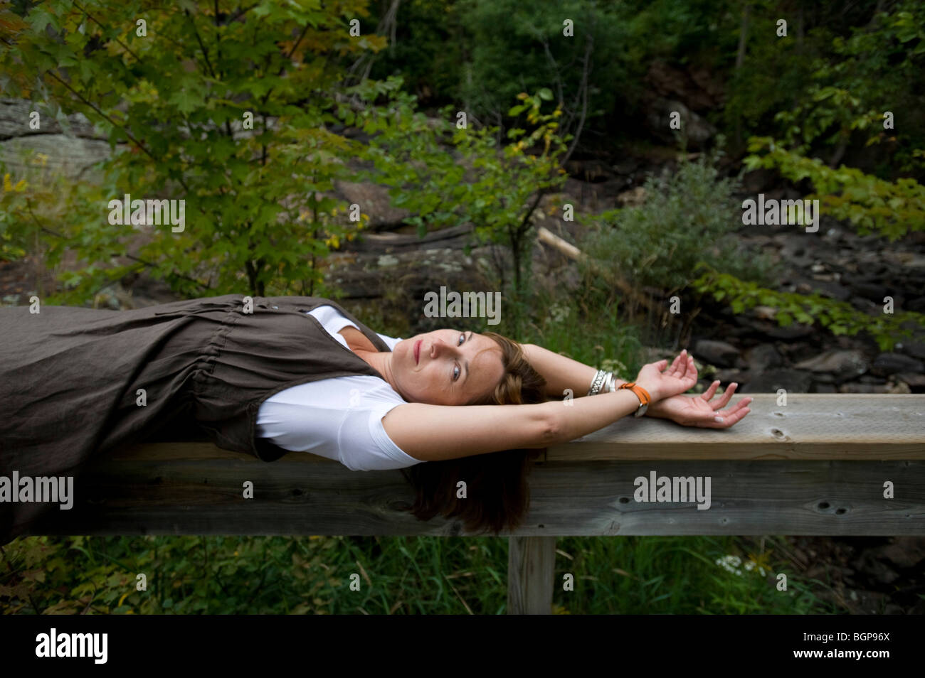 Woman lying on bridge, Bracebridge, Ontario, Canada Stock Photo - Alamy