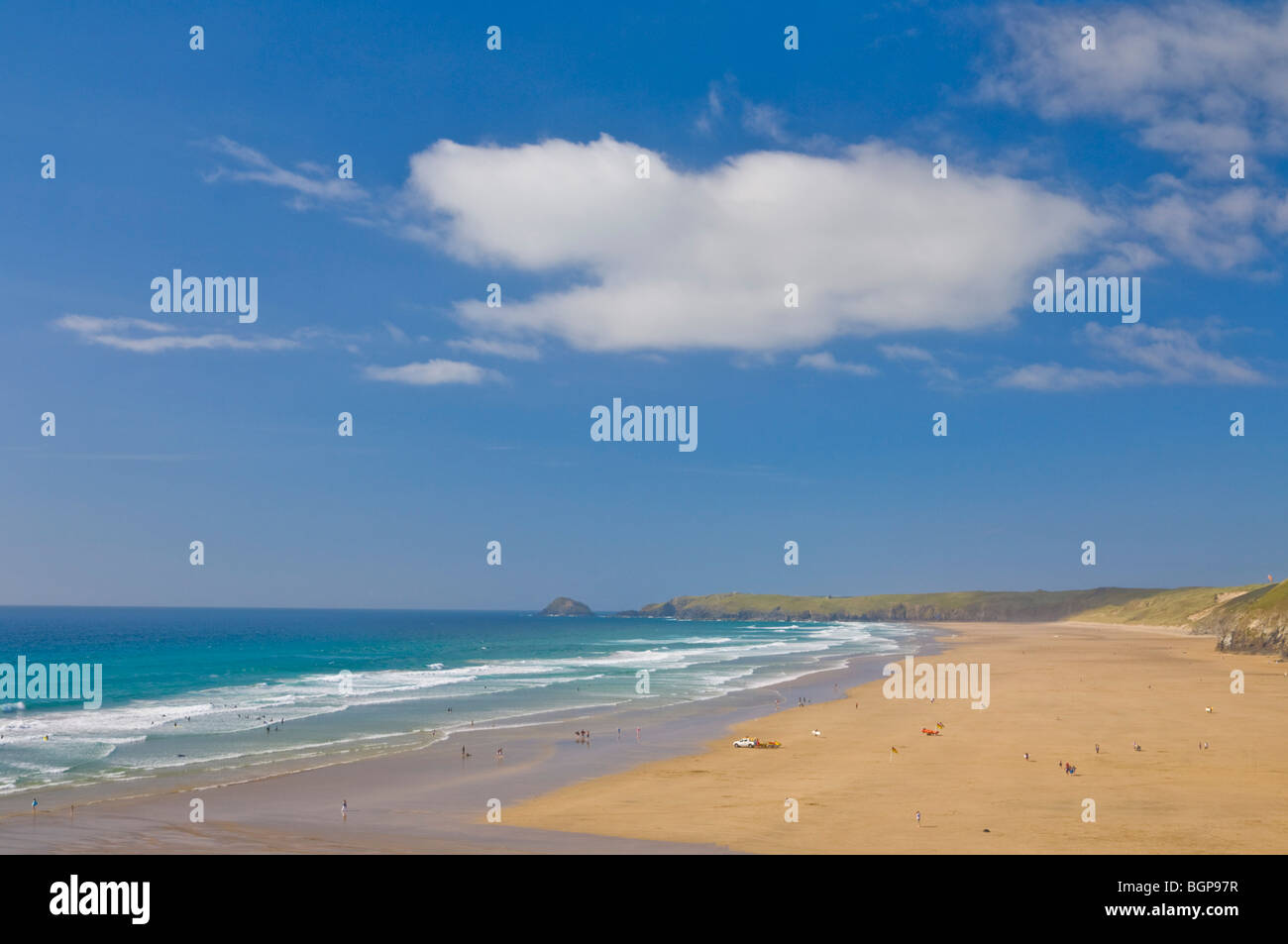Long beach and coastline with surfers, tourists and lifeguard patrols ...