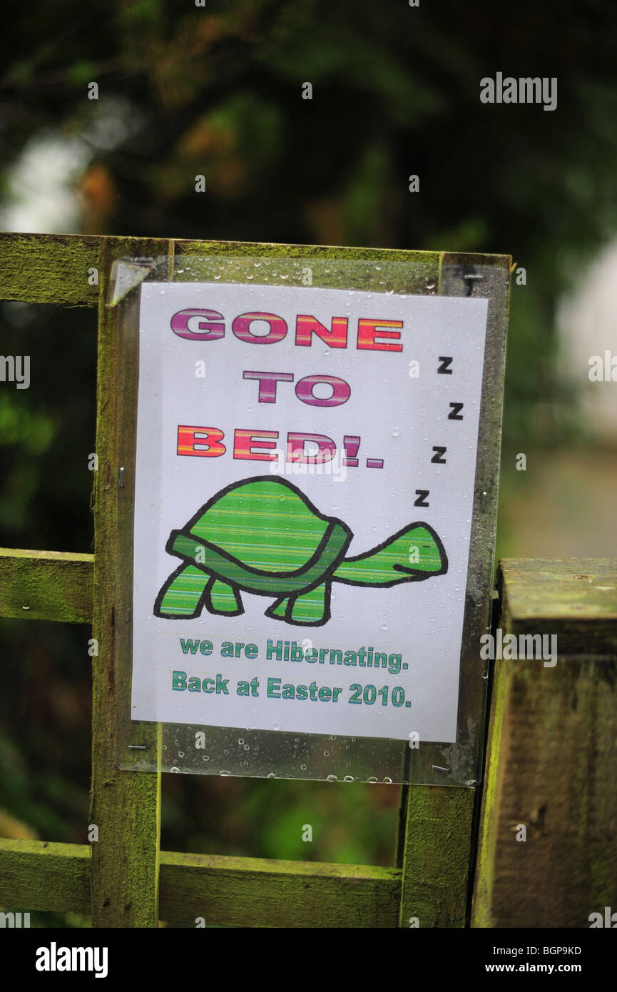 a sign at a tortoise garden illustrating hibernation, saying gone to ...