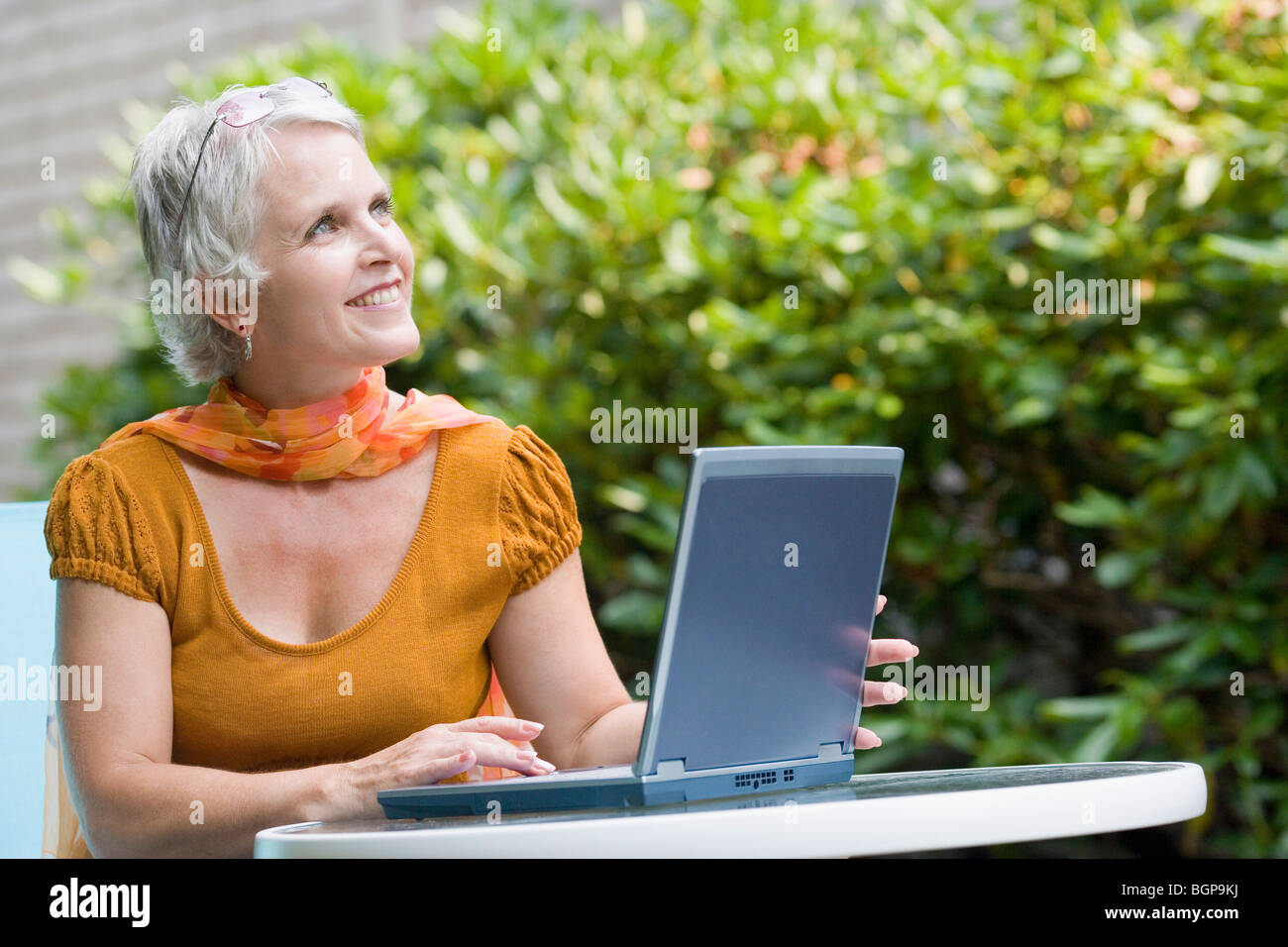 Mature woman laptop outdoors hi-res stock photography and images - Alamy