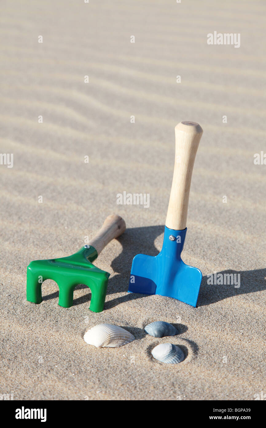 Toys lying next to some shells on the beach Stock Photo - Alamy