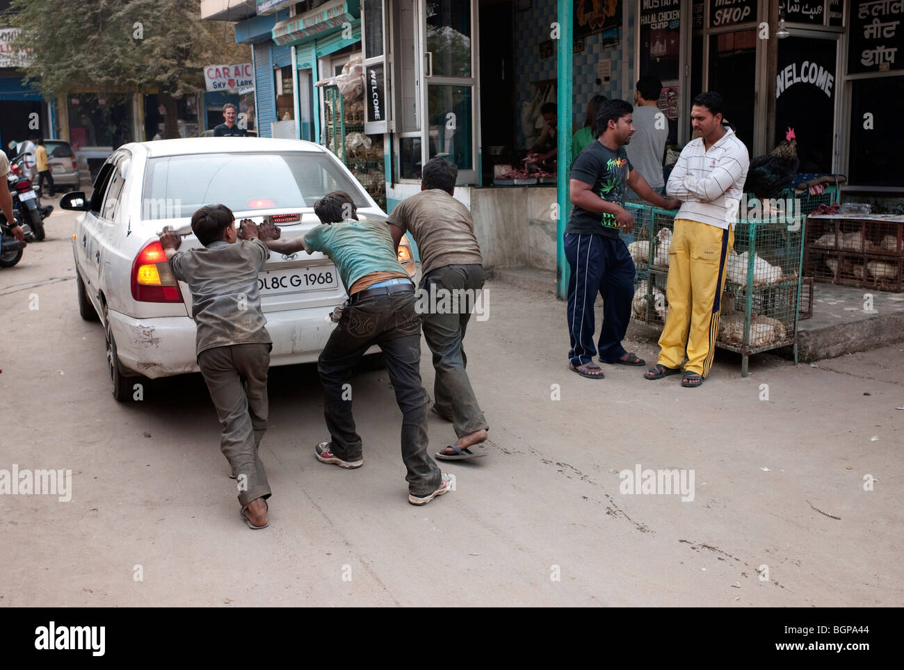 Indian men pushing car two hi-res stock photography and images - Alamy