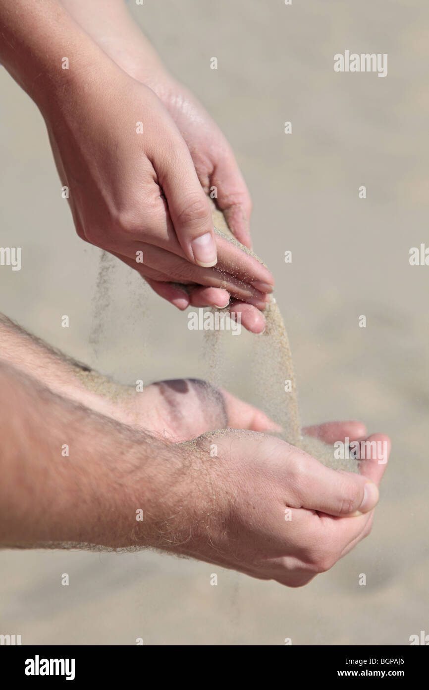 A person holding dry sand in his hands Stock Photo - Alamy