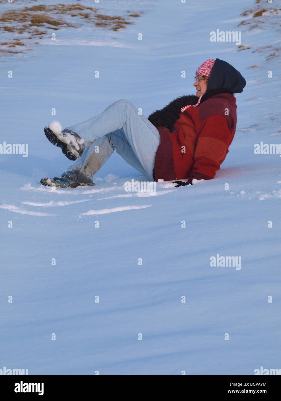 Woman falling over in the snow, Cornwall, UK Stock Photo - Alamy