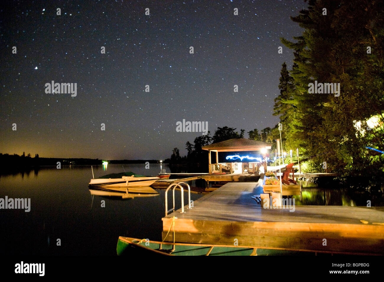 Cottage dock lit up at night, Lake of the Woods, Ontario, Canada Stock ...