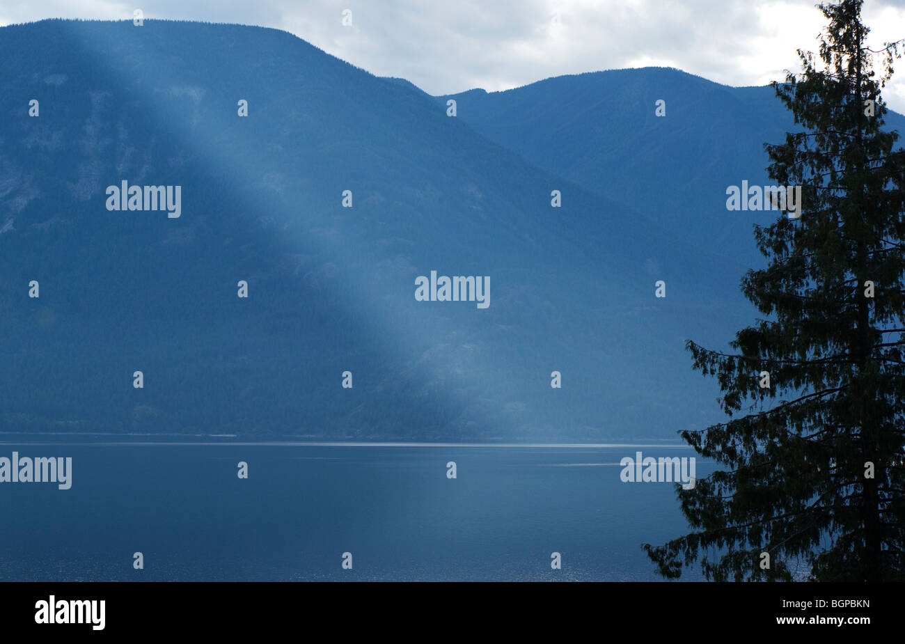 Sunlight hits mountain lake Stock Photo - Alamy