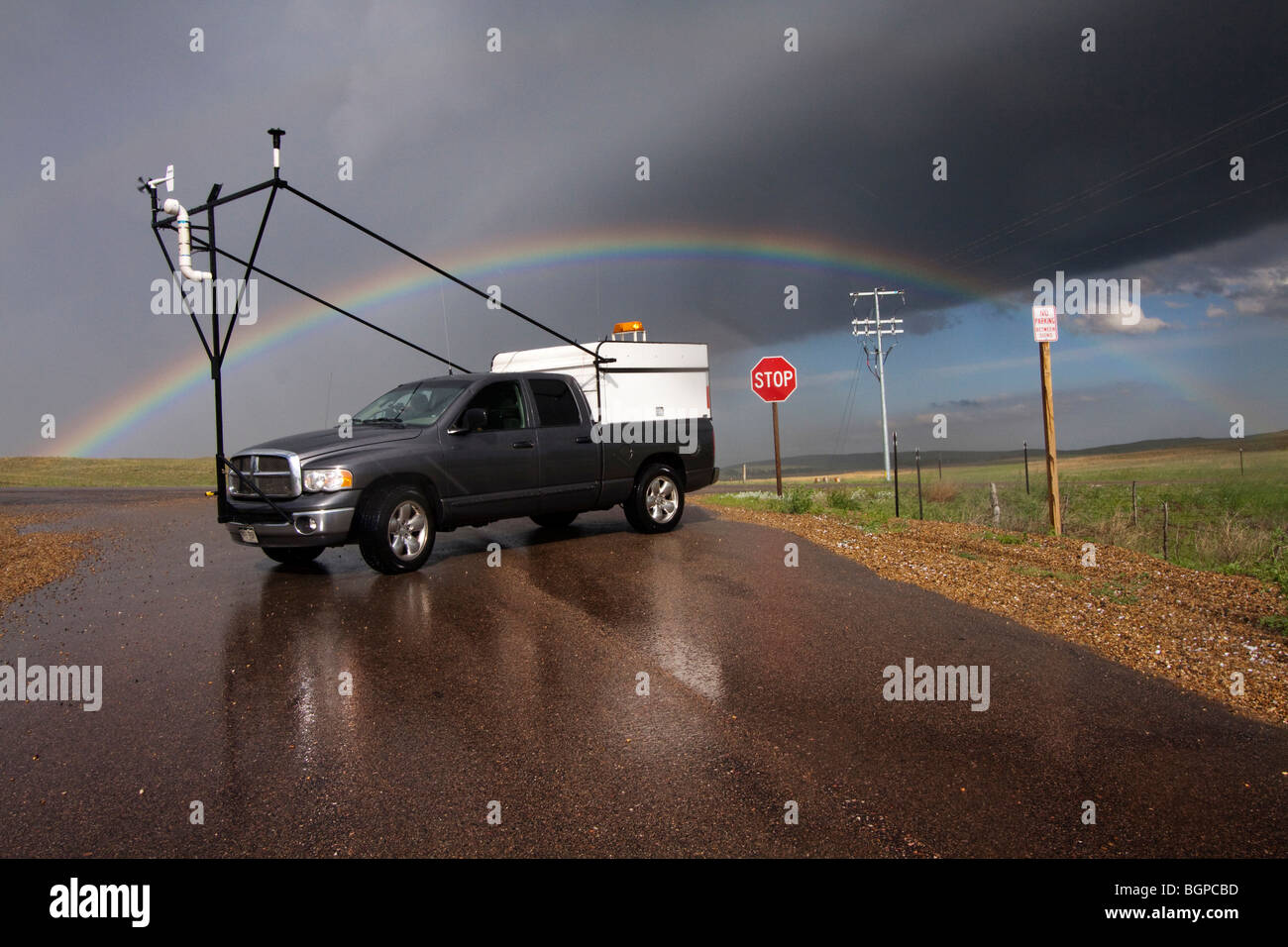 A storm chaser drives under a rainbow in rural during Project Vortex 2 ...