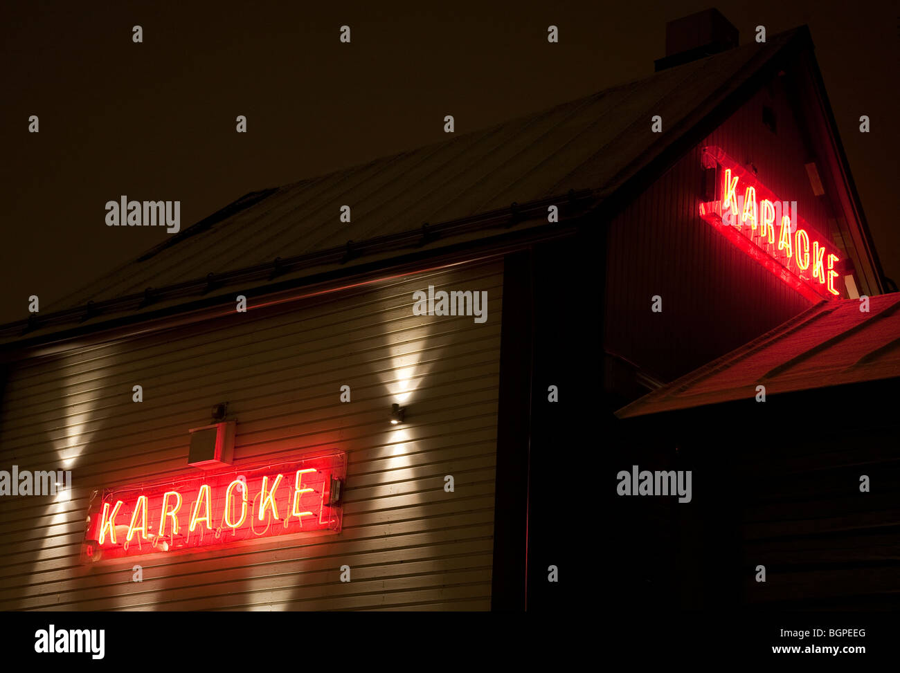 Illuminated red neon karaoke signs on wall at night , Finland Stock ...