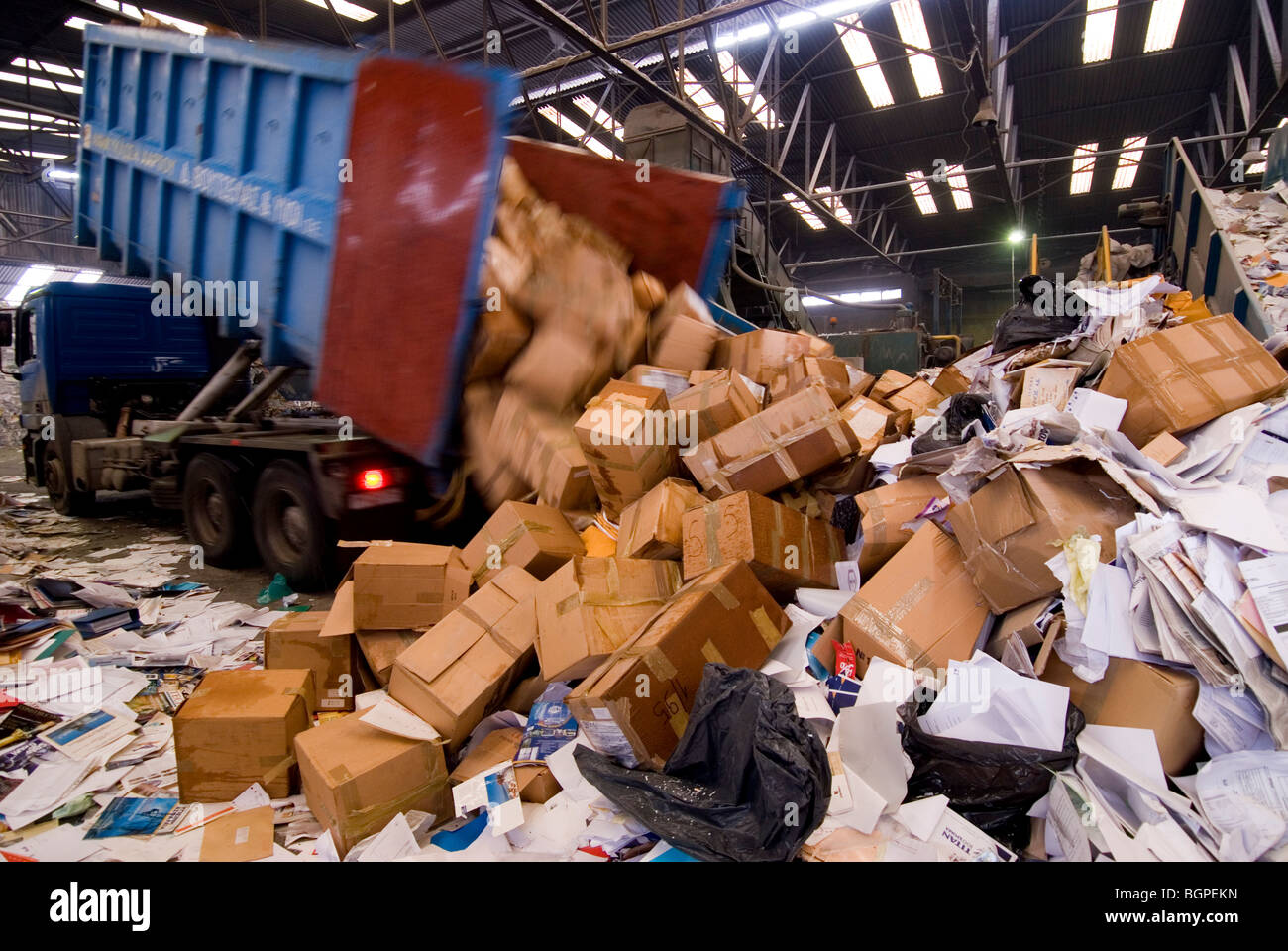 Lorry dumping boxes of waste paper for recycling Stock Photo - Alamy
