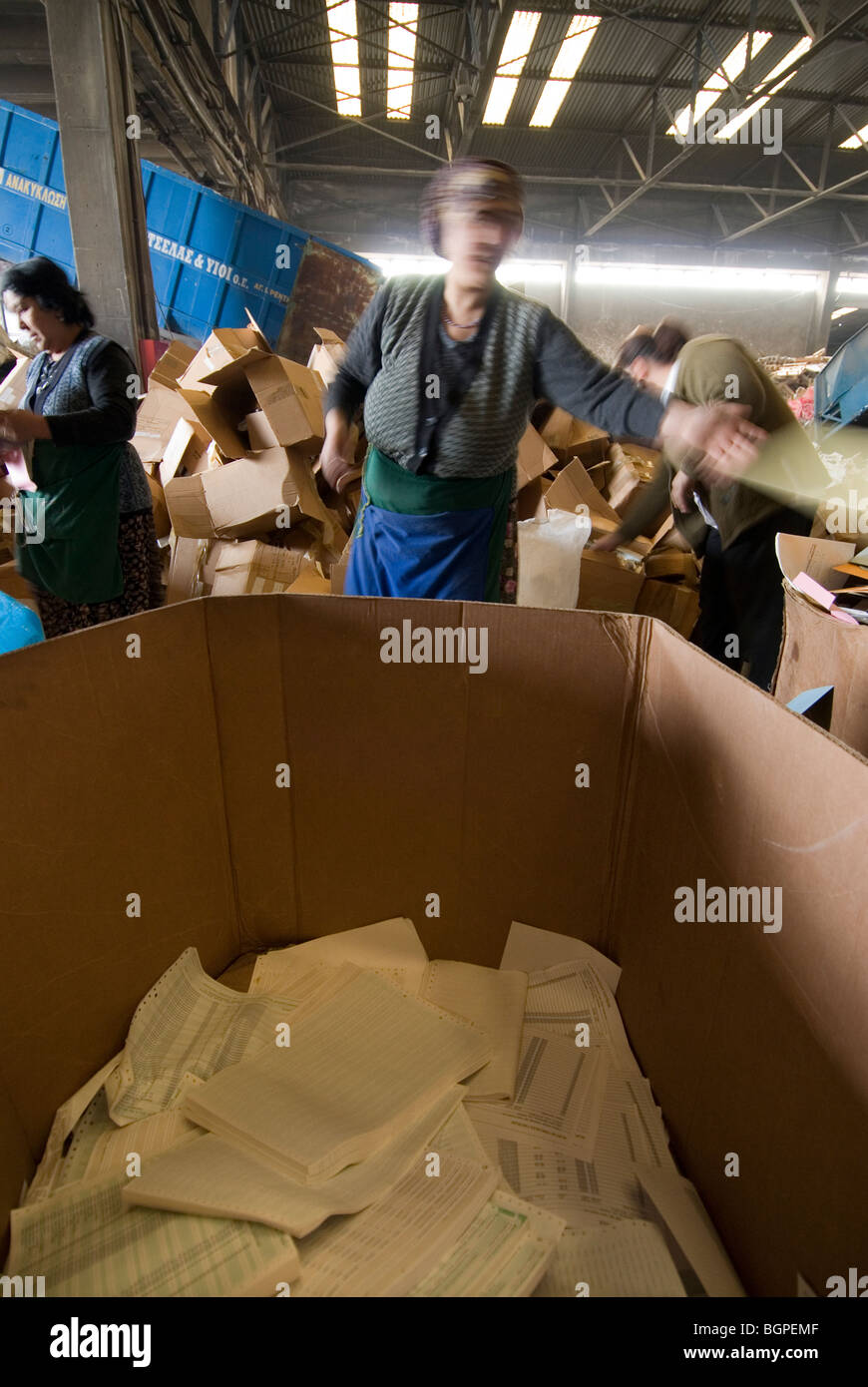 Manual sorting of different types of waste paper before the recycling ...