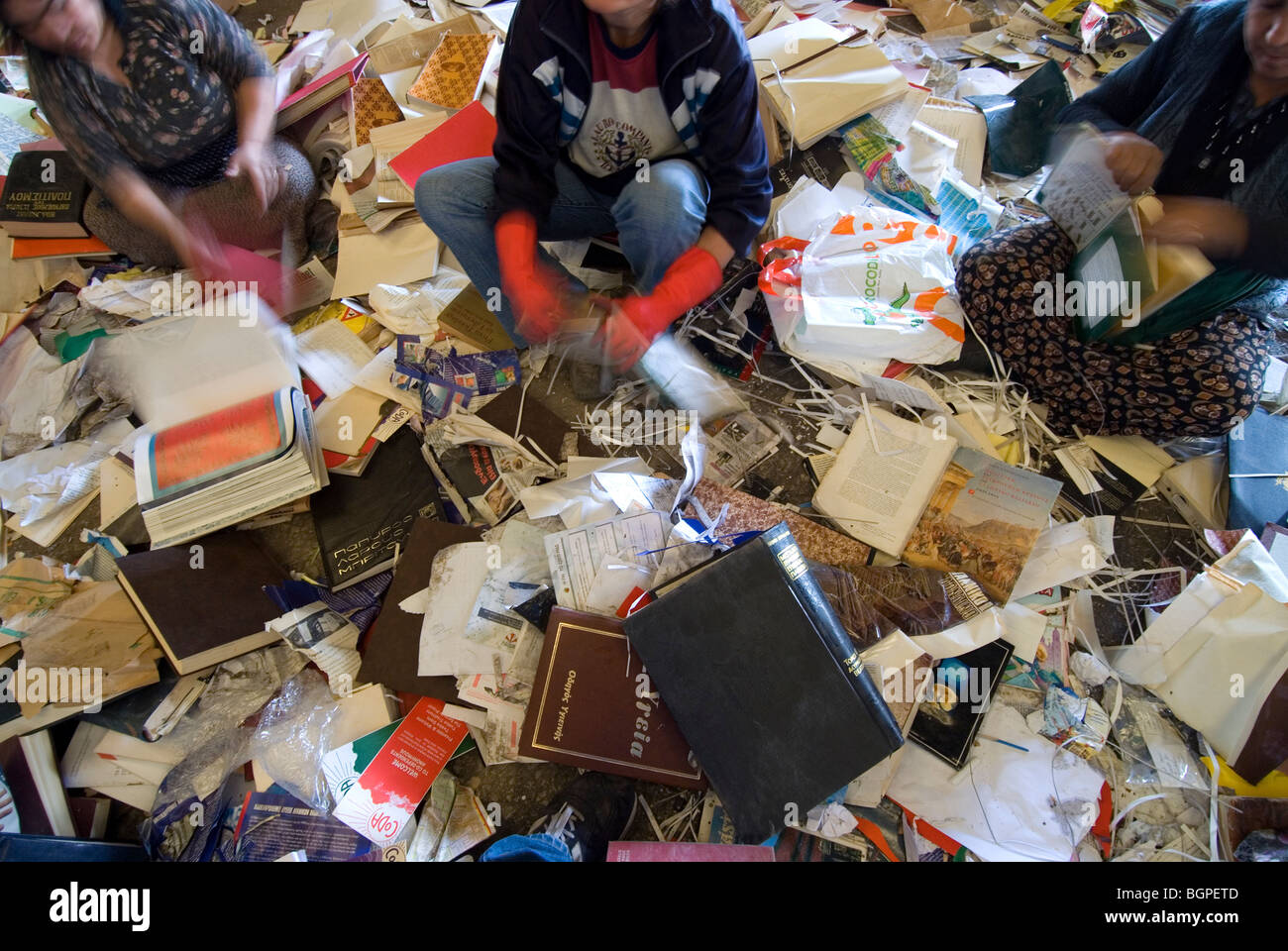 Women sorting manually different types of waste paper before the ...
