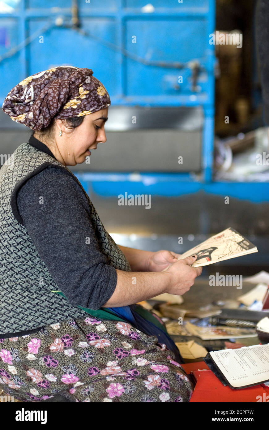 Woman sorting manually different types of waste paper before the ...