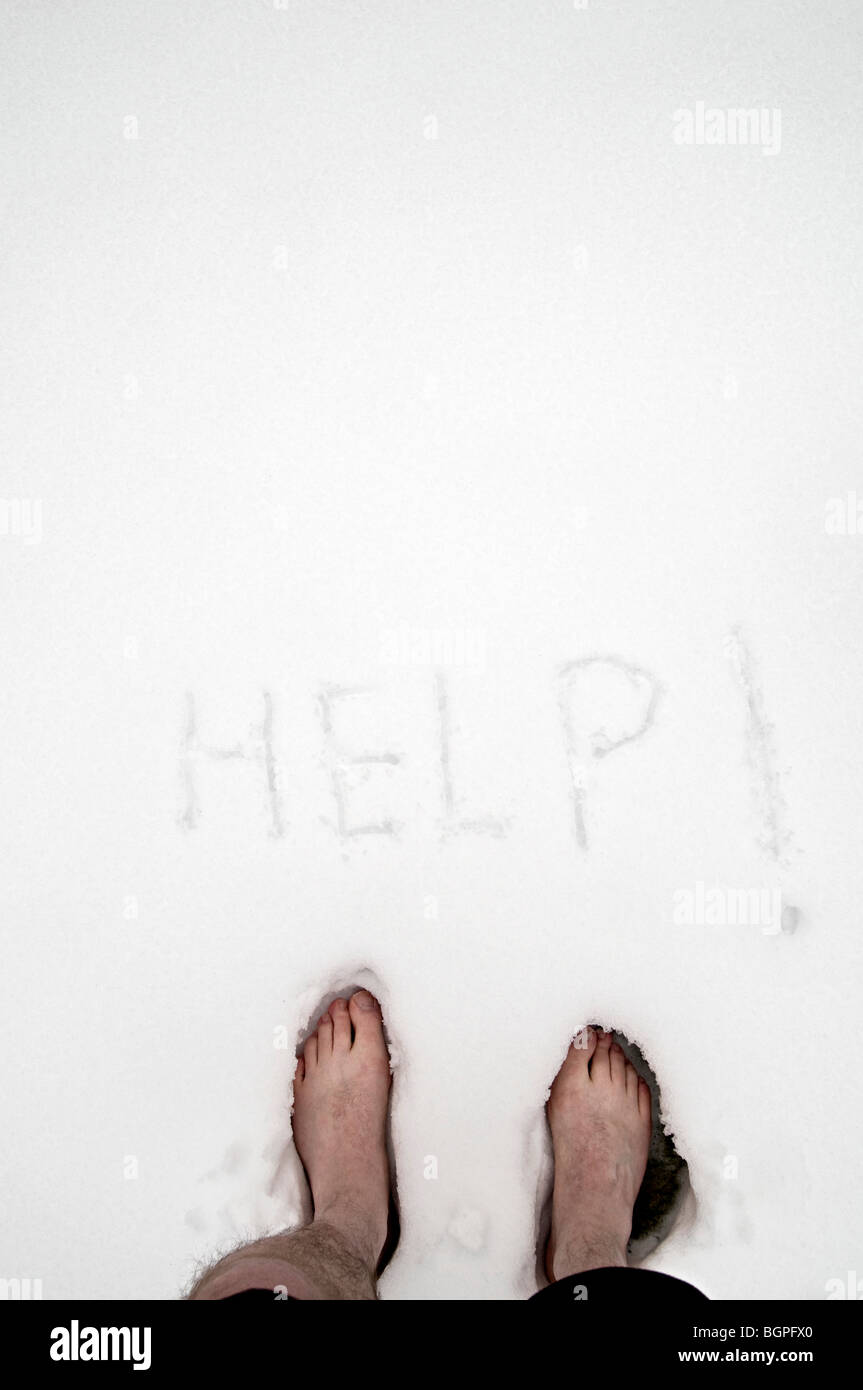 a pair of mens feet in the cold snow with a rescue message written in ...