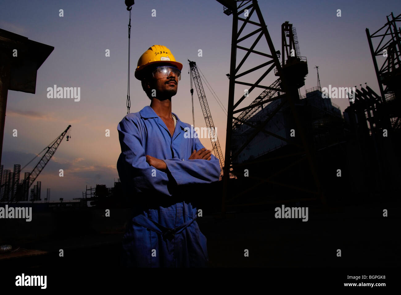 Worker poses on construction site Stock Photo - Alamy