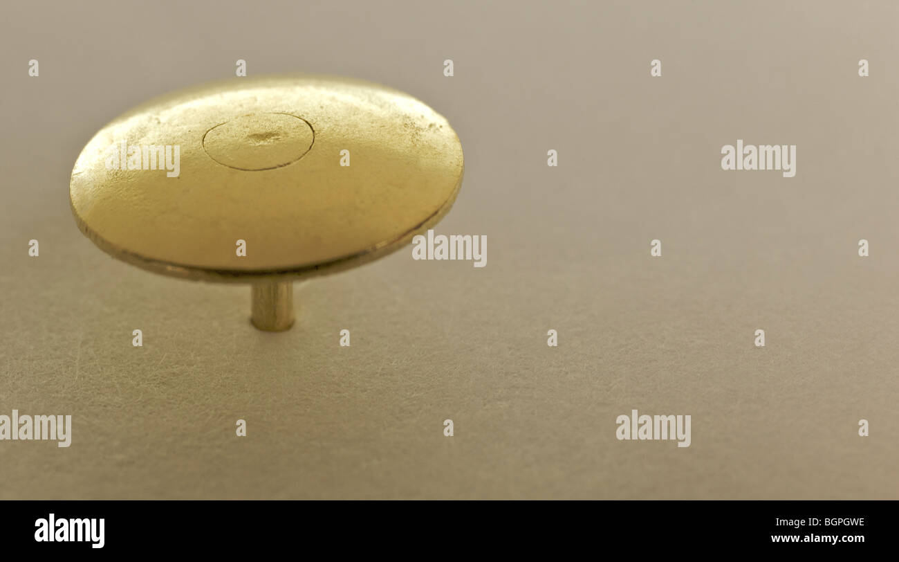 close up of gold coloured drawing pin Stock Photo - Alamy