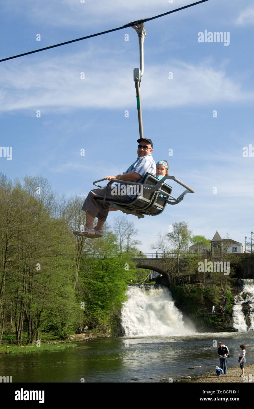 Tourists in chair lift above the river Amblève in front of the ...