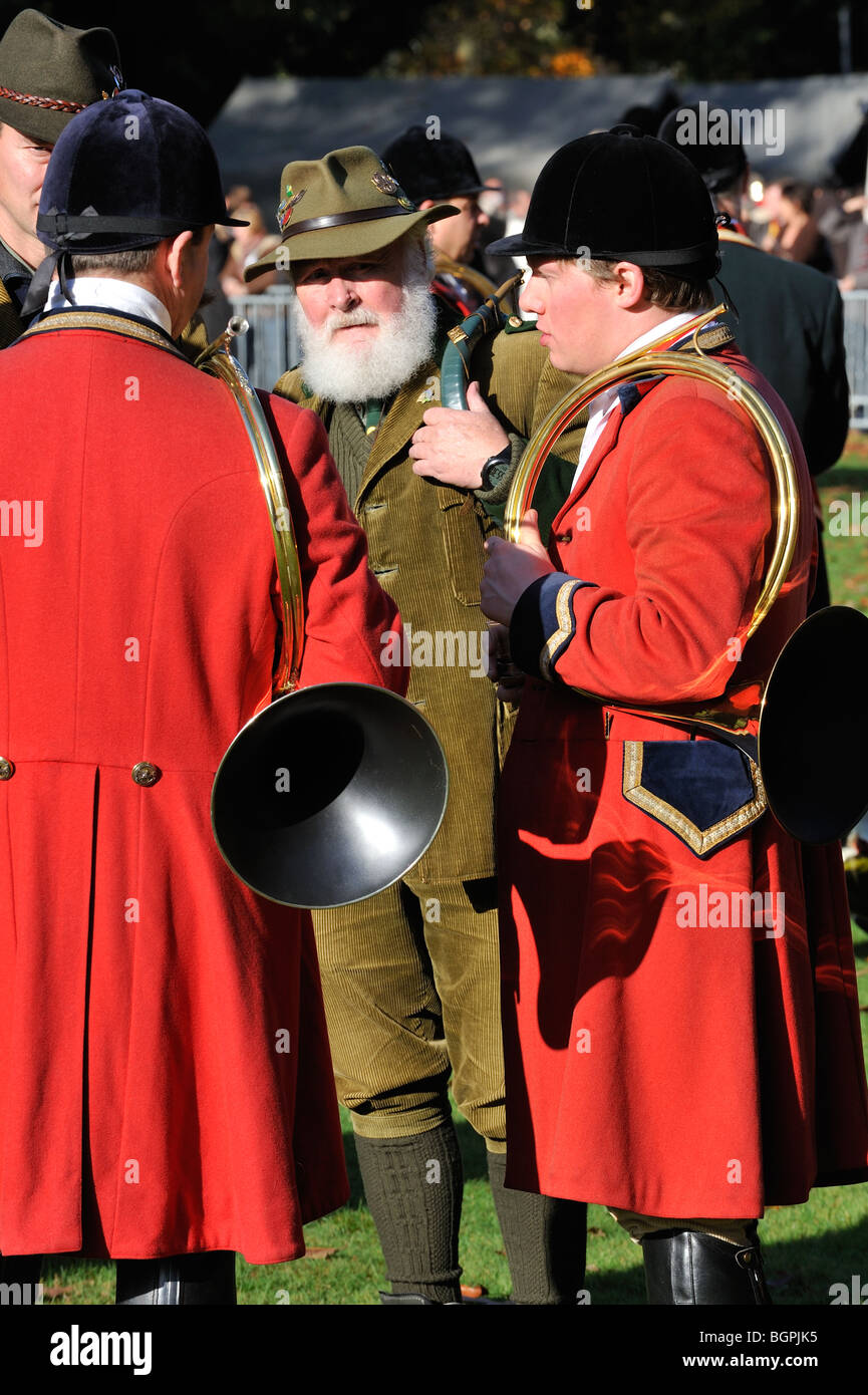Hunters wearing red coats with hunting horns / bugles during ...