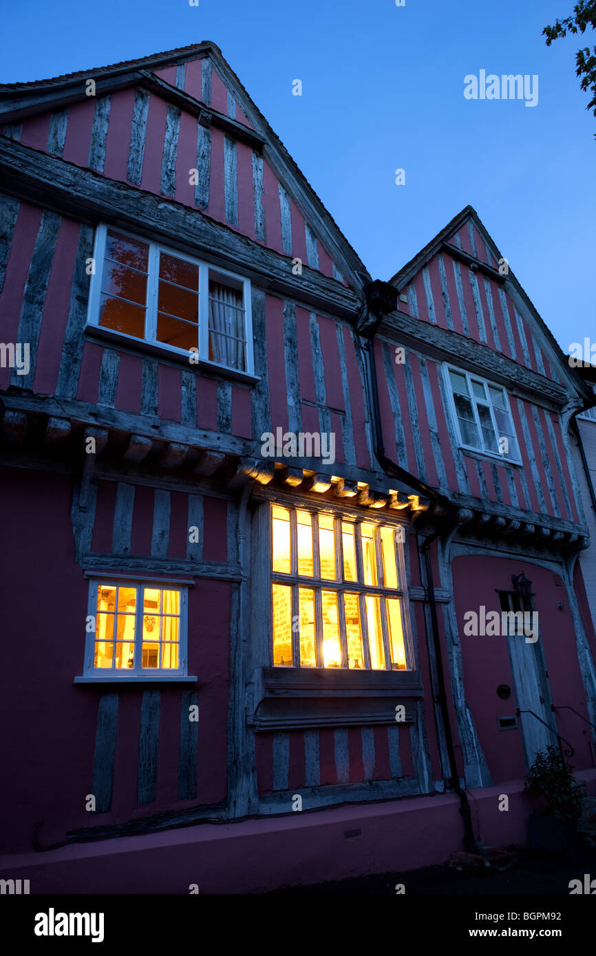 Medieval timber framed house with illuminated window at dusk Stock ...