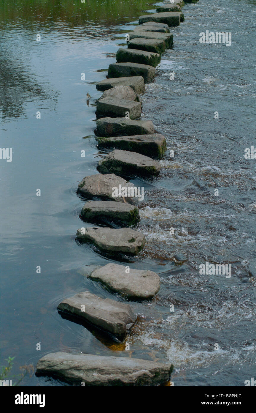 Stepping stones across a river Stock Photo - Alamy
