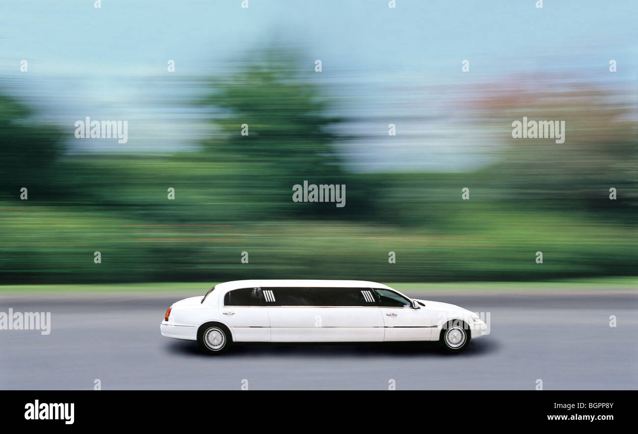 Long car white limousine speedy on the road. Speed effect by motion ...