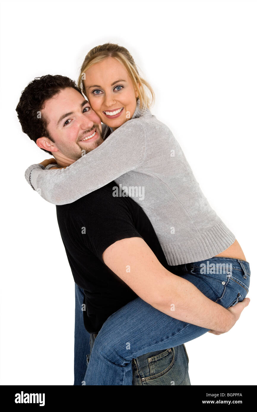 Studio photograph of young Caucasian couple posing with their arms ...