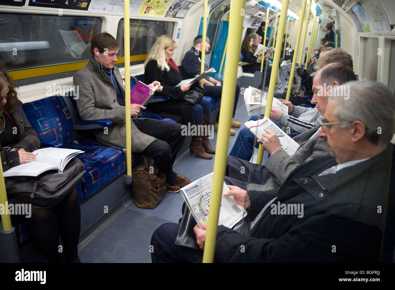People Reading Newspaper On Train