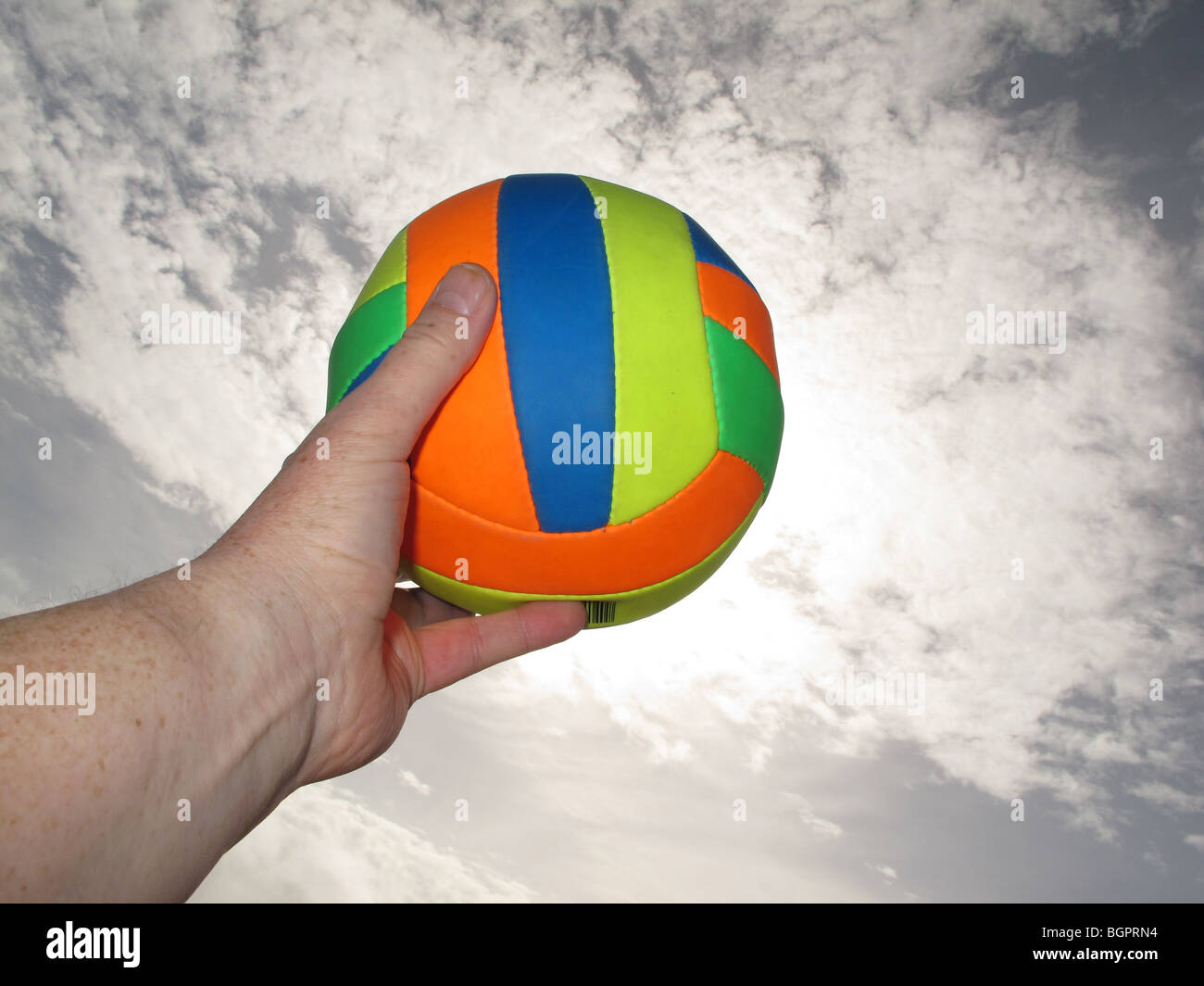 Hand grasping Ball in the Sky - team Building Stock Photo - Alamy