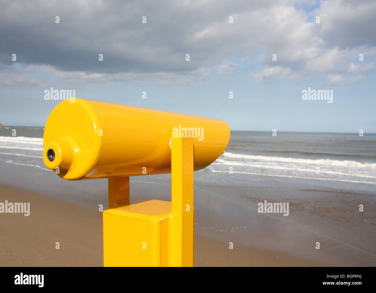 Yellow telescope looking out to sea on the English coast. A traditional ...