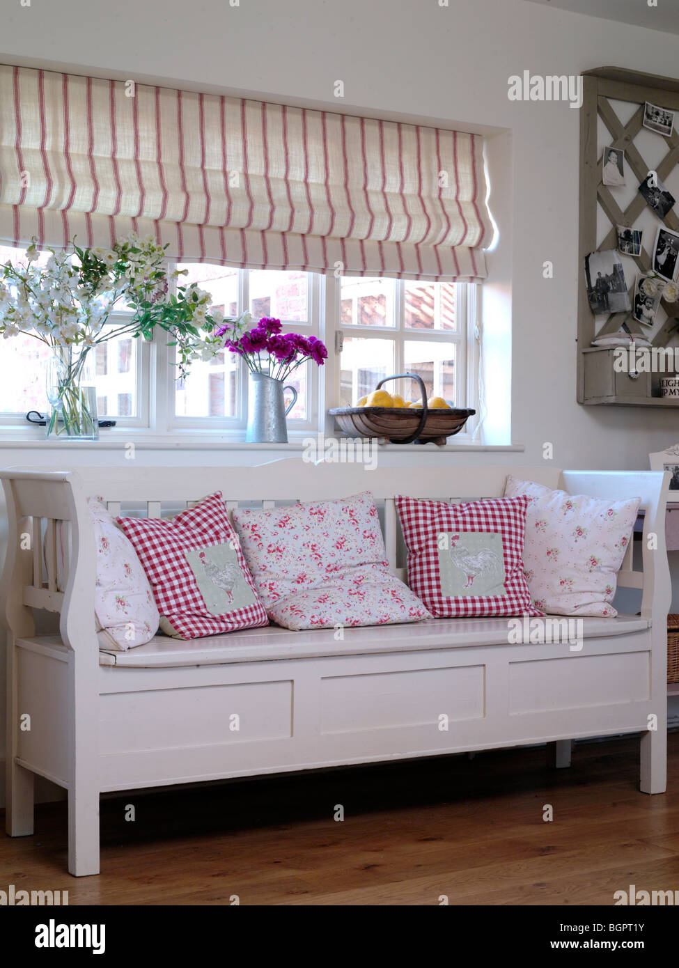 cream painted country kitchen settle with cushions Stock Photo - Alamy