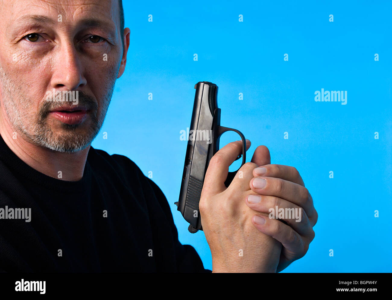 Close up portrait man gun looking hi-res stock photography and images ...